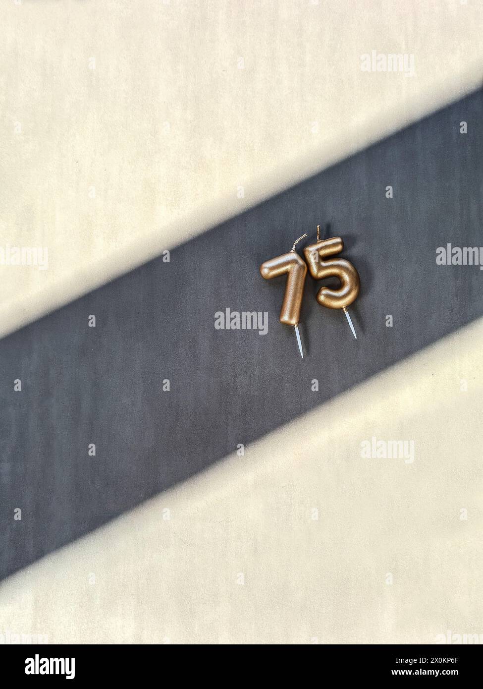 The number 75 as birthday and anniversary candles in sunlight with ...