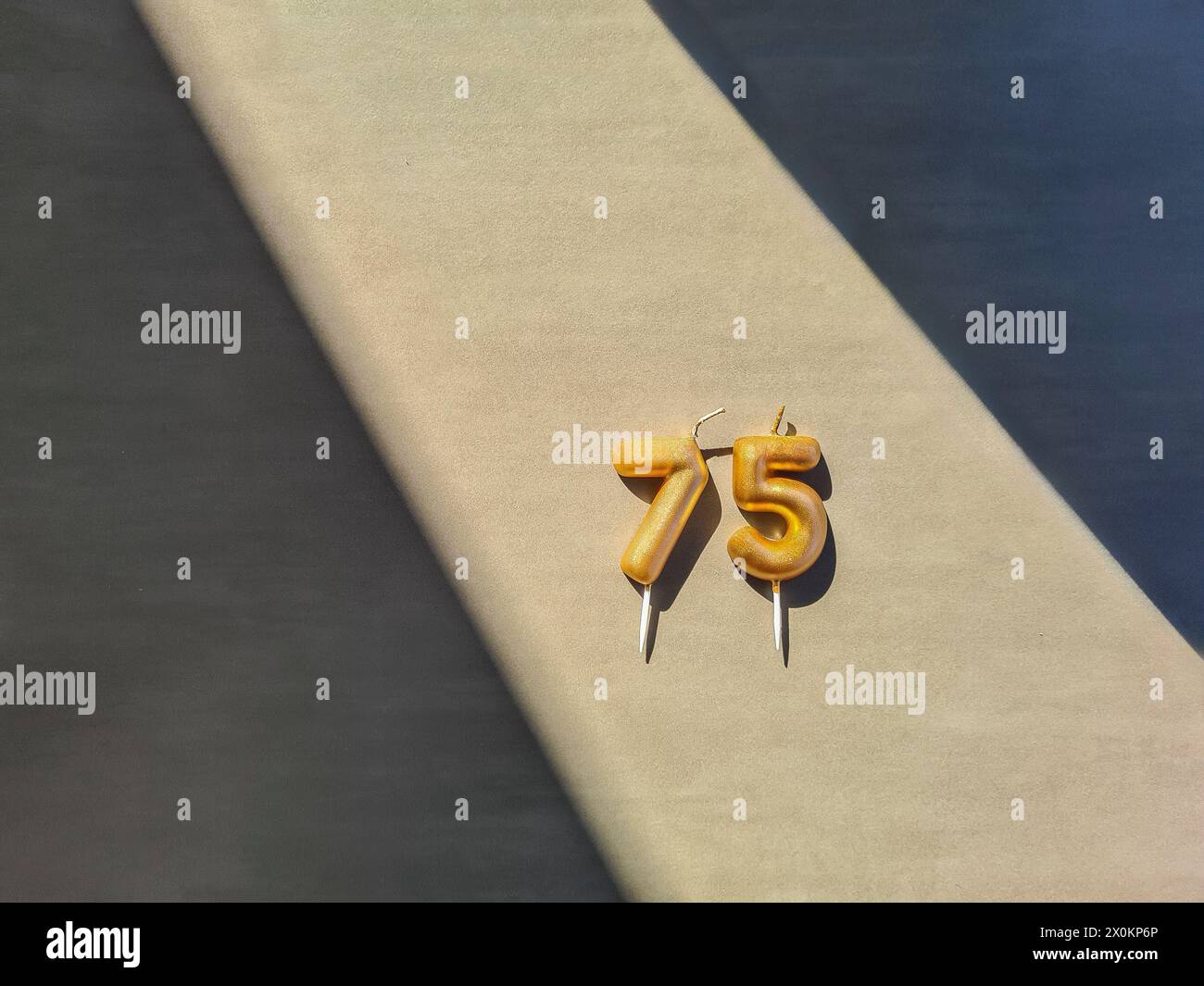 The number 75 as birthday and anniversary candles in sunlight with ...