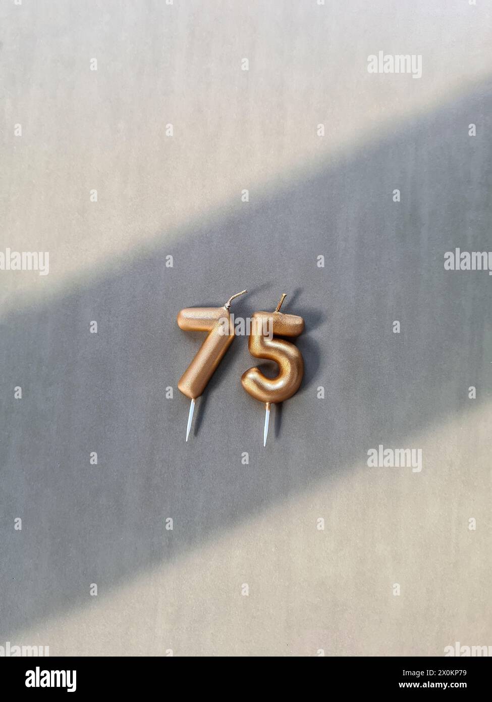 The number 75 as birthday and anniversary candles in sunlight with ...