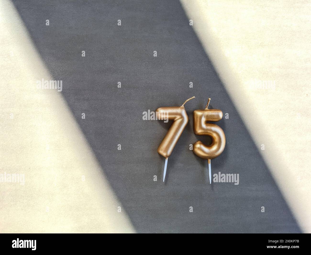 The number 75 as birthday and anniversary candles in sunlight with ...