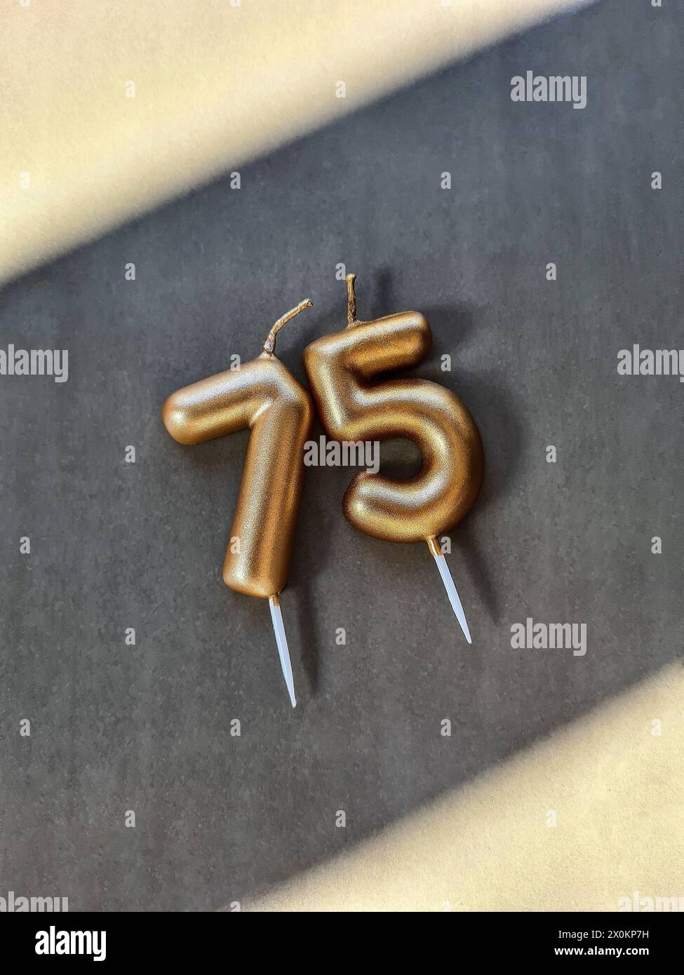 The number 75 as birthday and anniversary candles in sunlight with ...