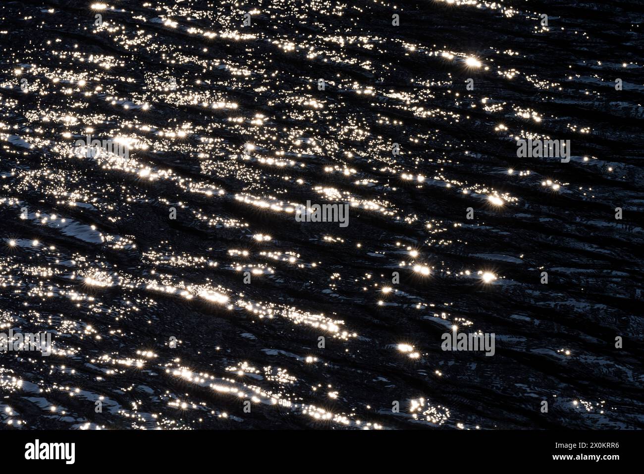 Light reflections caused by sunlight on the surface of a lake, small ...