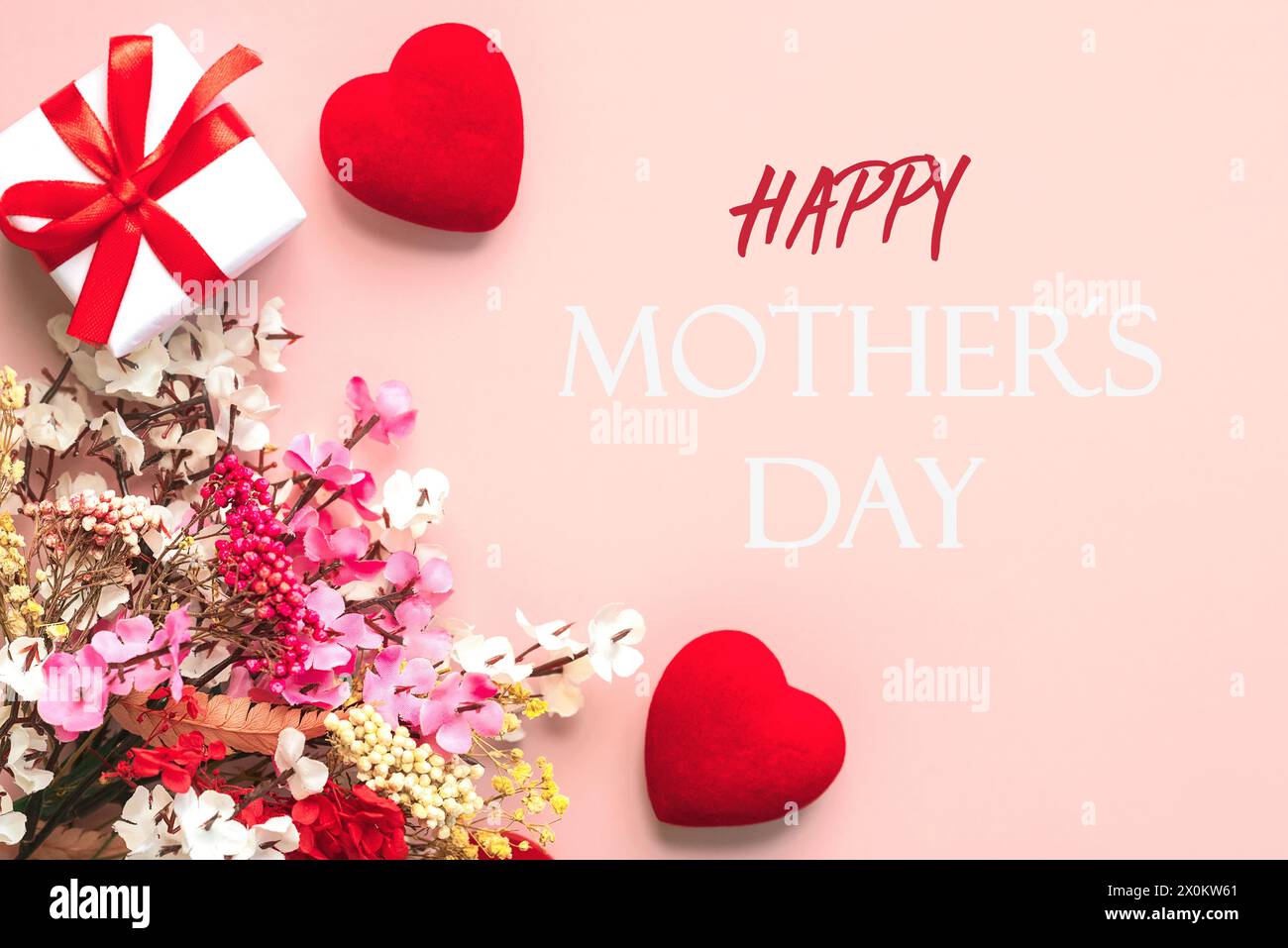 Happy Mother's Day. Top view of flowers,gift box and red hearts with ...