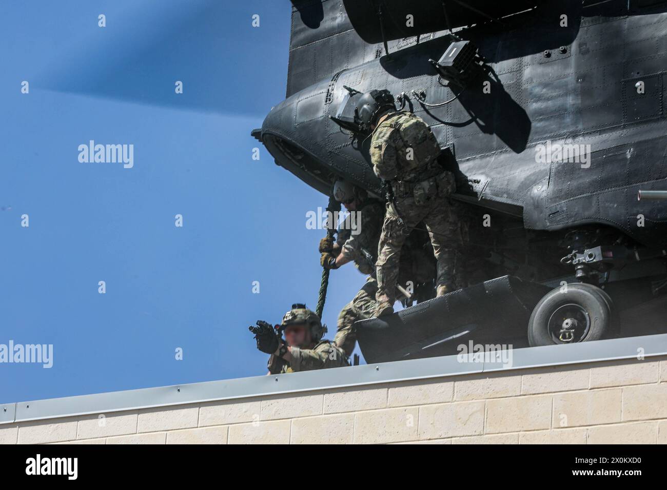 U.S. Army Rangers fast-rope out of an MH-47 Chinook helicopter and move ...