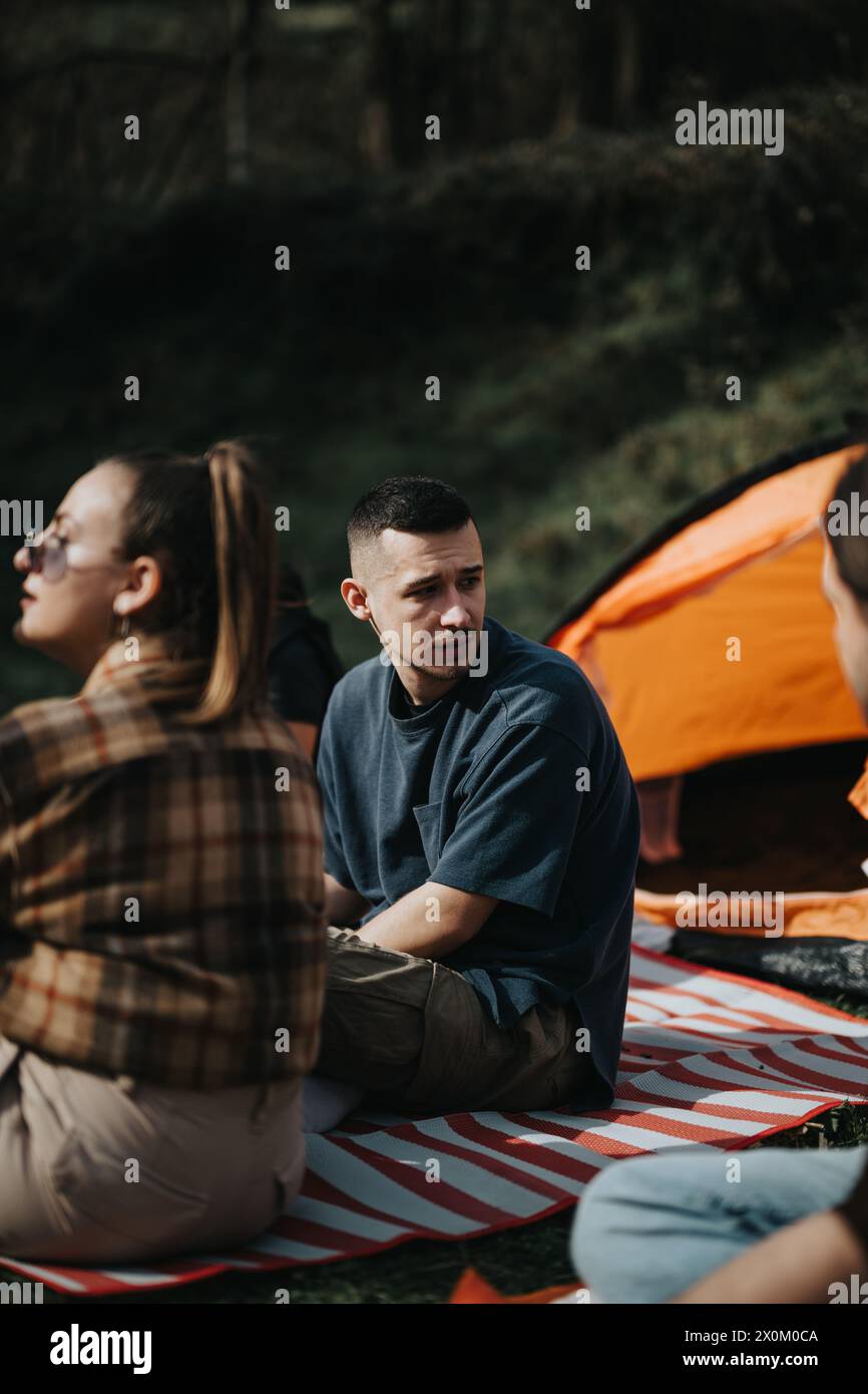 Friends enjoying a relaxed outdoor camping trip in nature Stock Photo ...