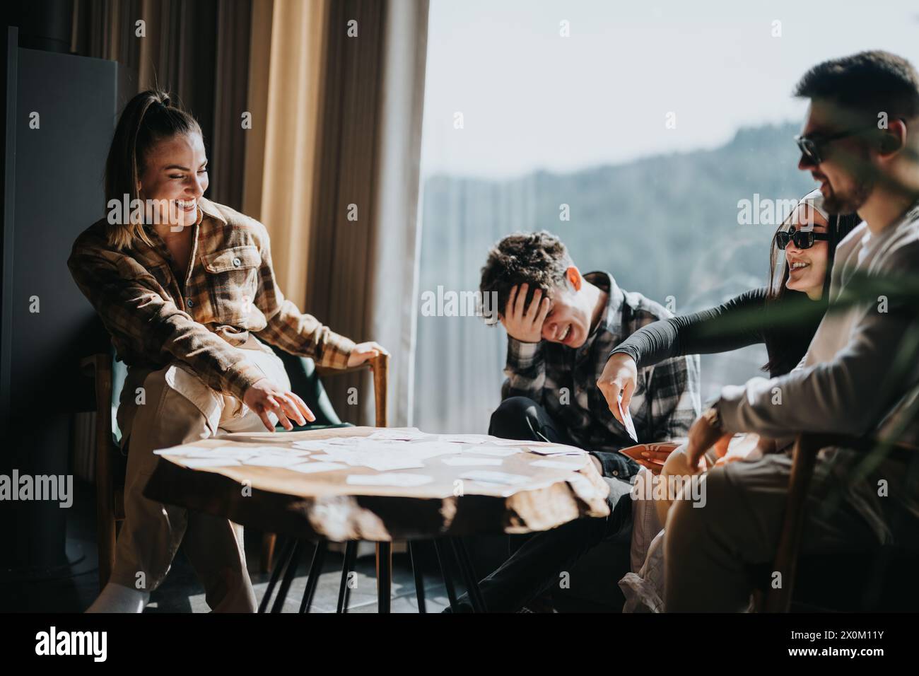 Diverse friends conversing around table hi-res stock photography and ...