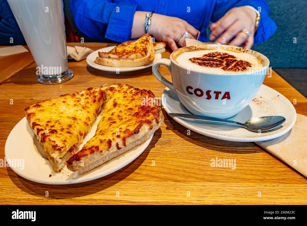 A ham and cheese toasted sandwich and a cappuccino coffee at a Costa ...