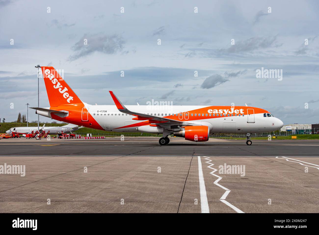 An EasyJet aeroplane in its distinctive white and orange livery taxiing ...
