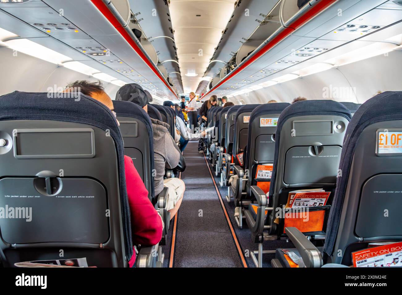 View looking forwards along the aisle of an aeroplane on an EasyJet ...
