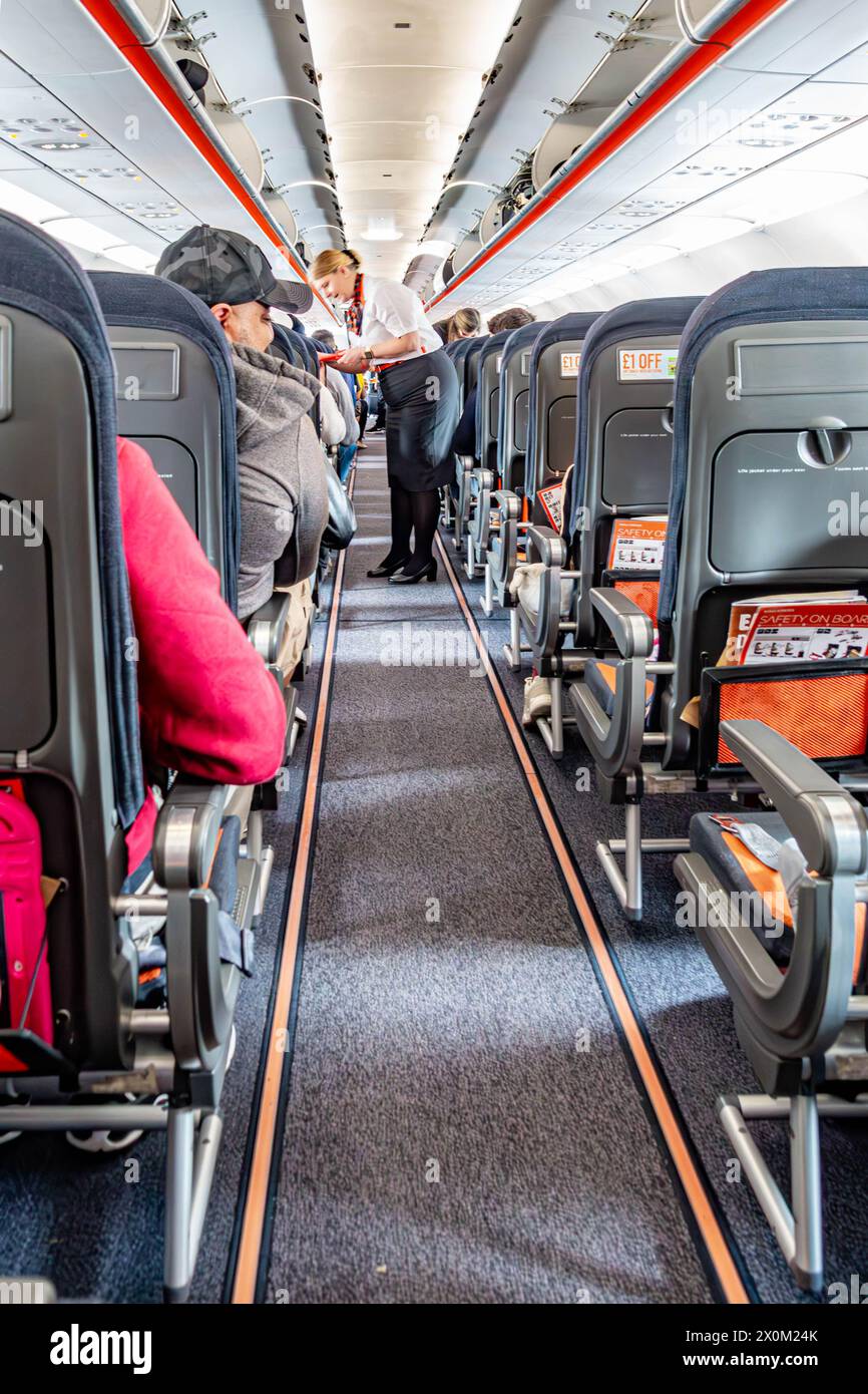 View looking forwards along the aisle of an aeroplane on an EasyJet ...