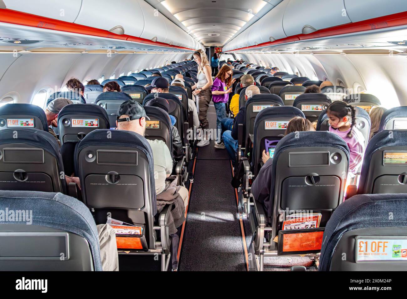 View looking forwards along the aisle of an aeroplane on an EasyJet ...