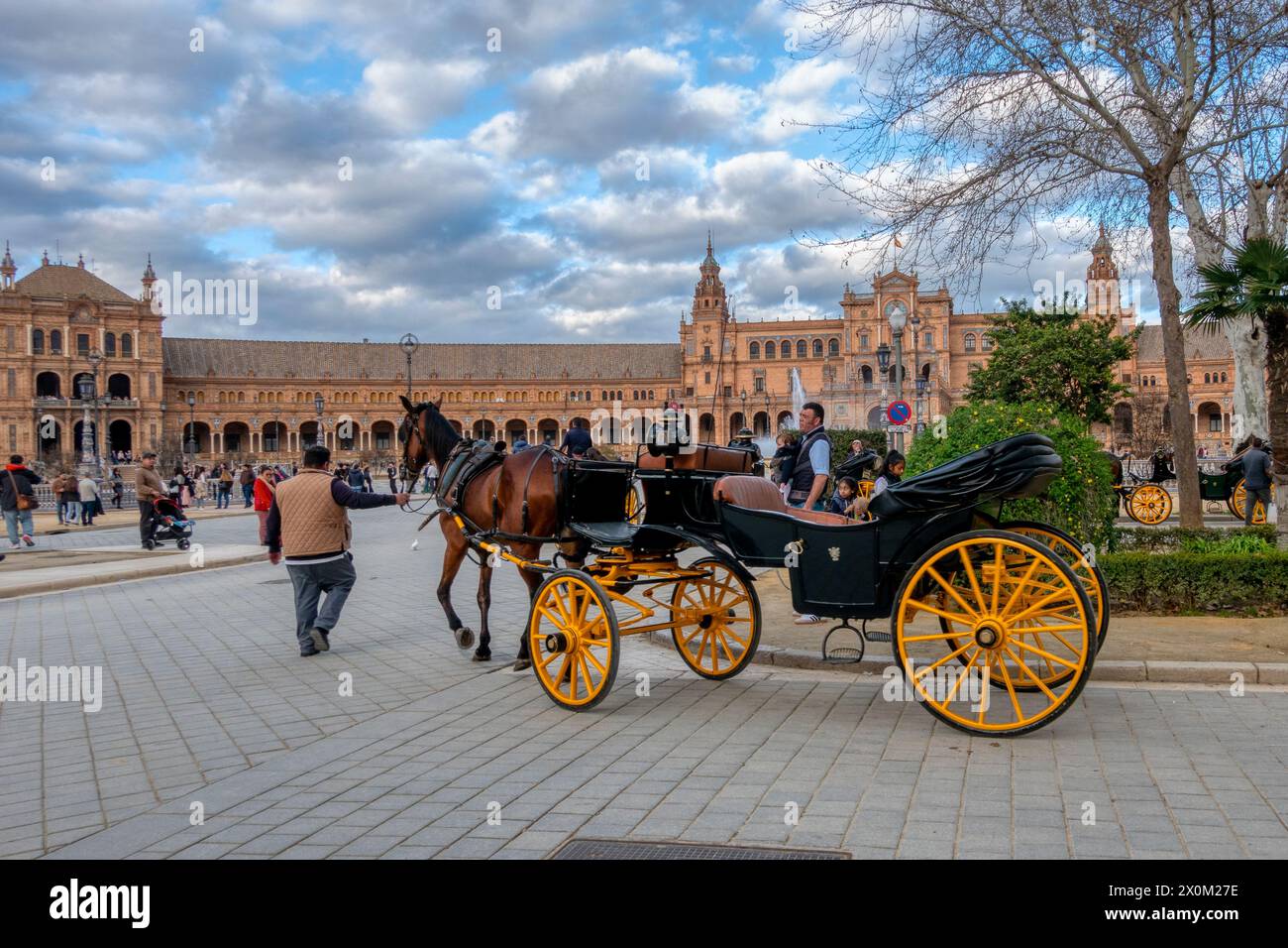Seville, Spain - March 3, 2024: Horse-drawn carriages carrying tourists ...