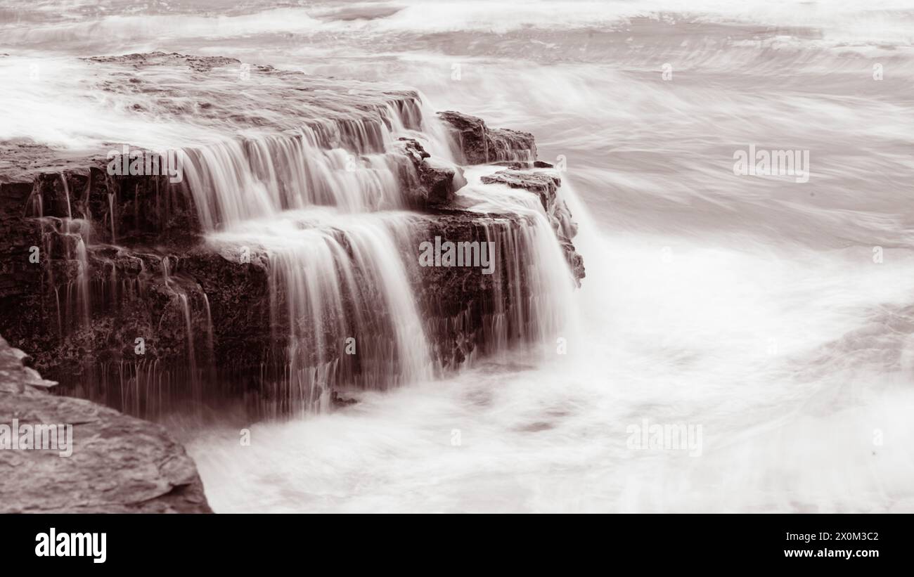 Water flows from big rocks at Four Mile Beach, California Stock Photo ...