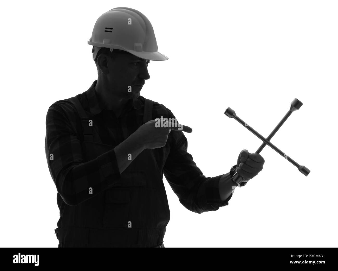 Silhouette of male worker pointing at cross wrench on white background ...
