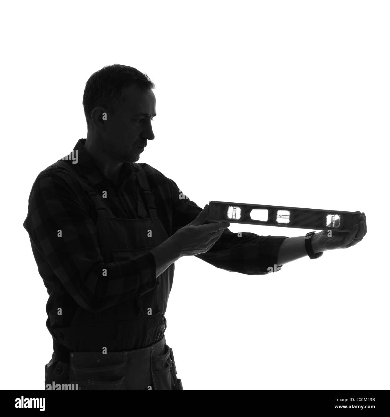 Silhouette of male worker with level on white background Stock Photo ...