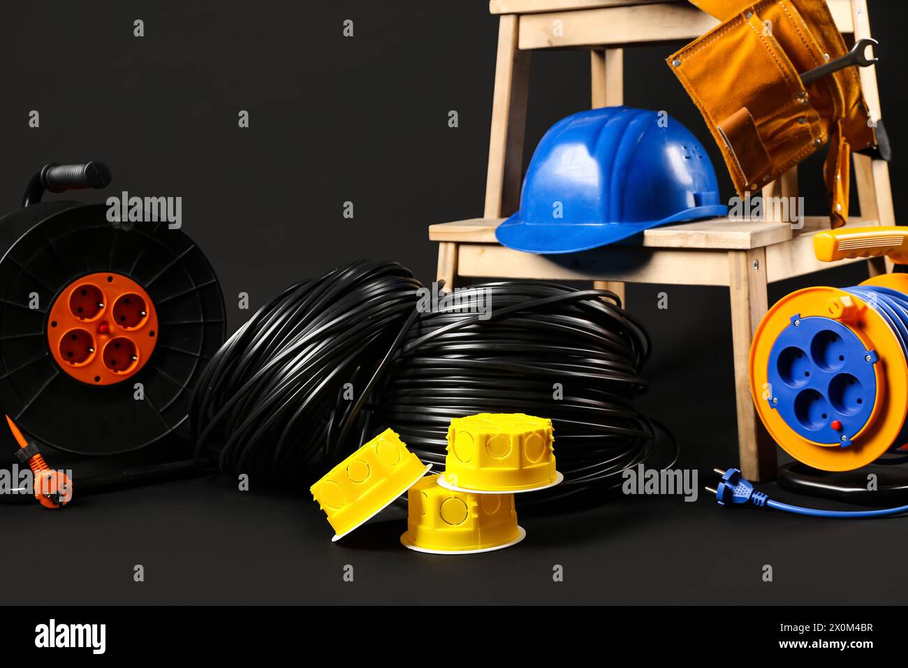 Stepladder with hardhat, rolled wires, extension cable reels and ...