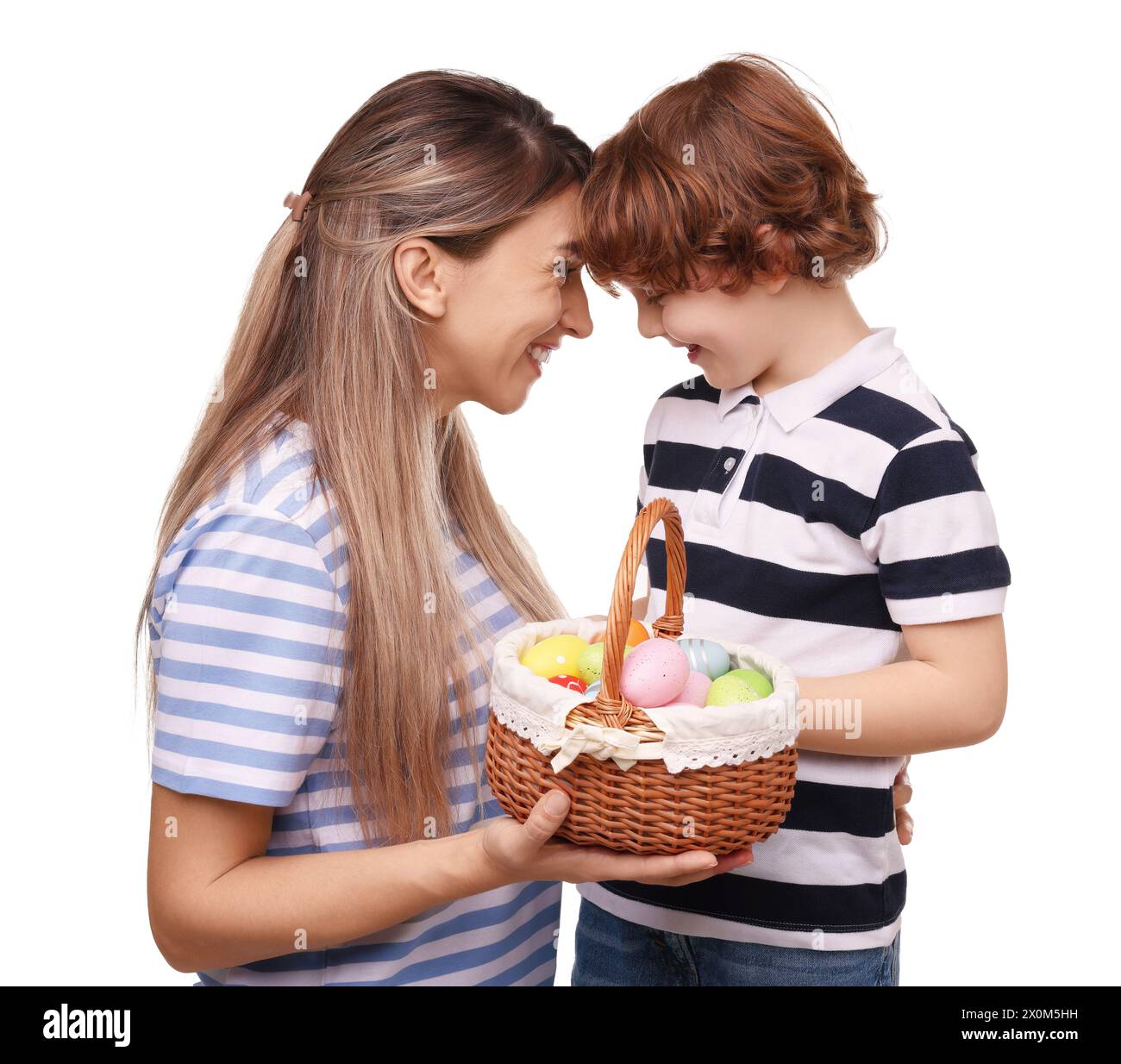 Easter celebration. Happy mother and her cute little son with wicker ...