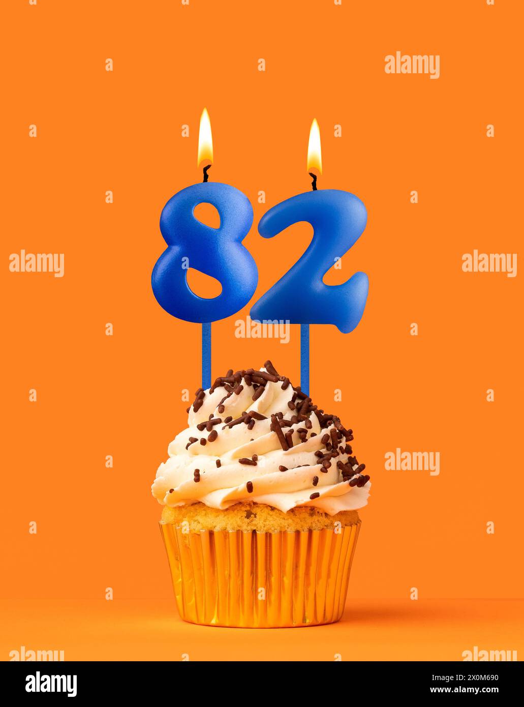 Blue birthday candle and cupcake - Number 82 Stock Photo - Alamy