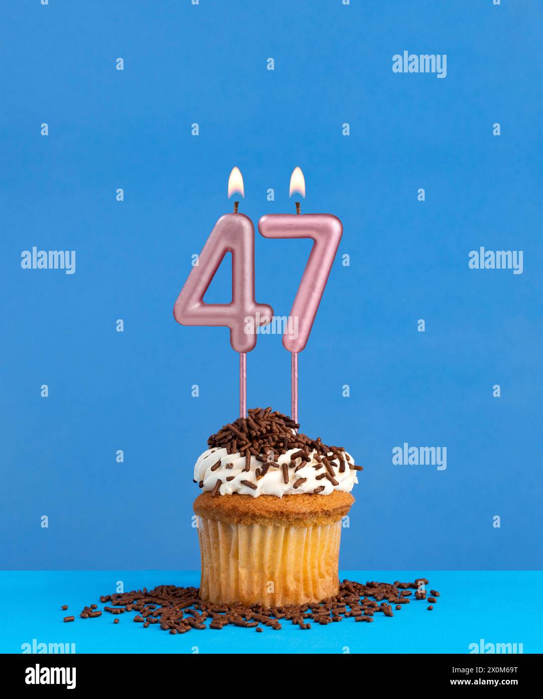 Birthday candle with cupcake on blue background - Number 47 Stock Photo ...