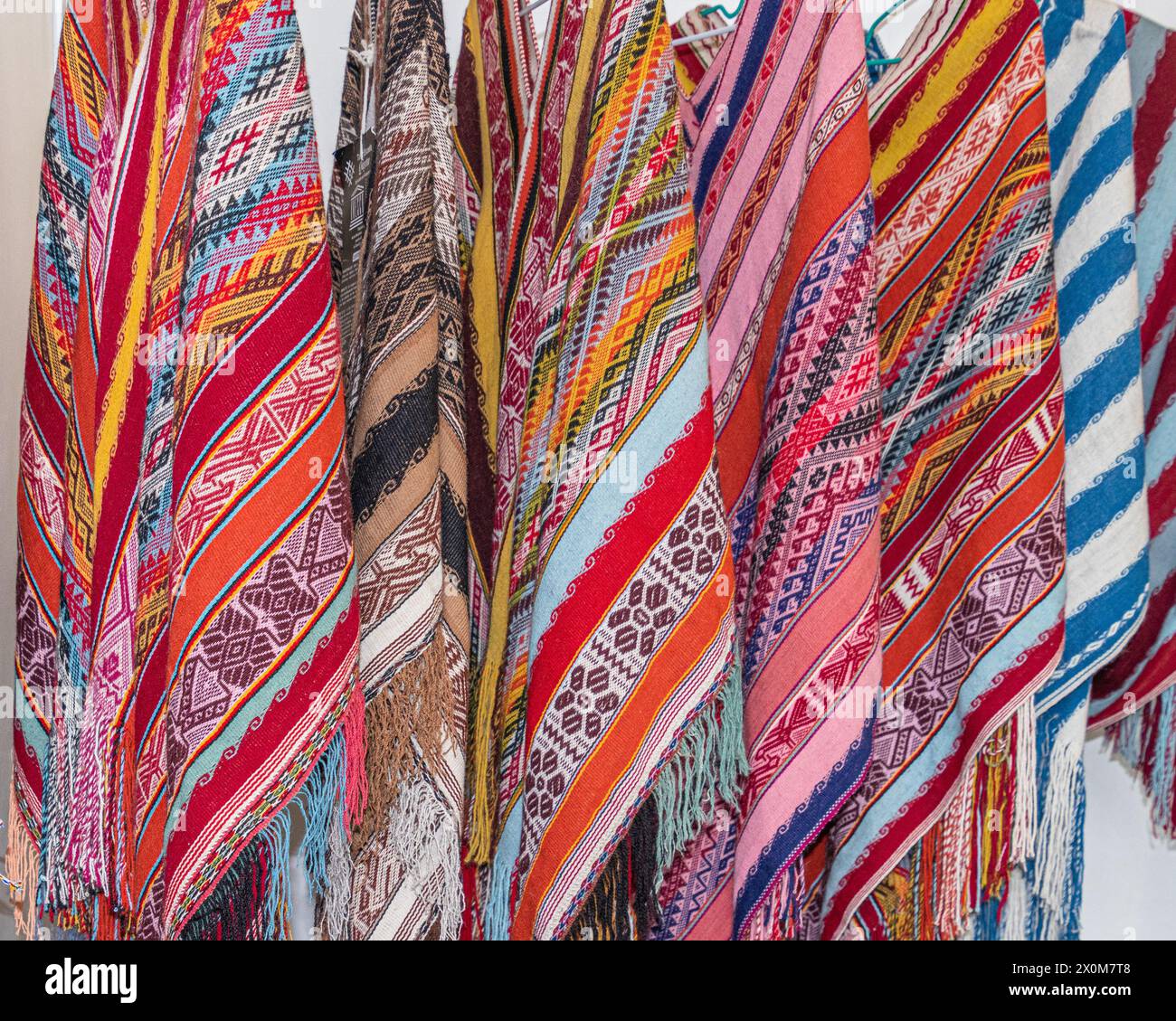 Collection of handmade Peruvian alpaca wool ponchos with traditional ...