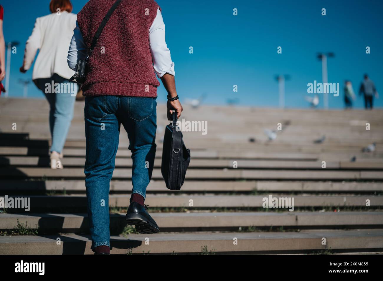 Business professional climbing stairs outdoors in urban setting Stock ...