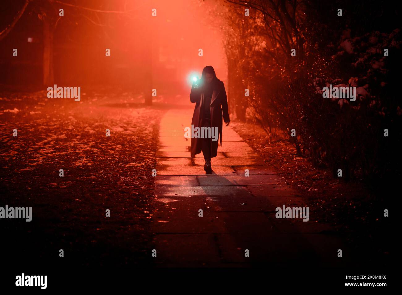 Young woman walking through a city at night with a torch Stock Photo ...