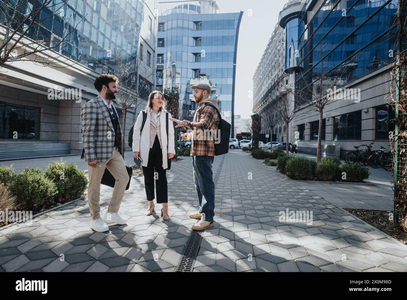 Young business professionals in casual attire engage in an outdoor ...