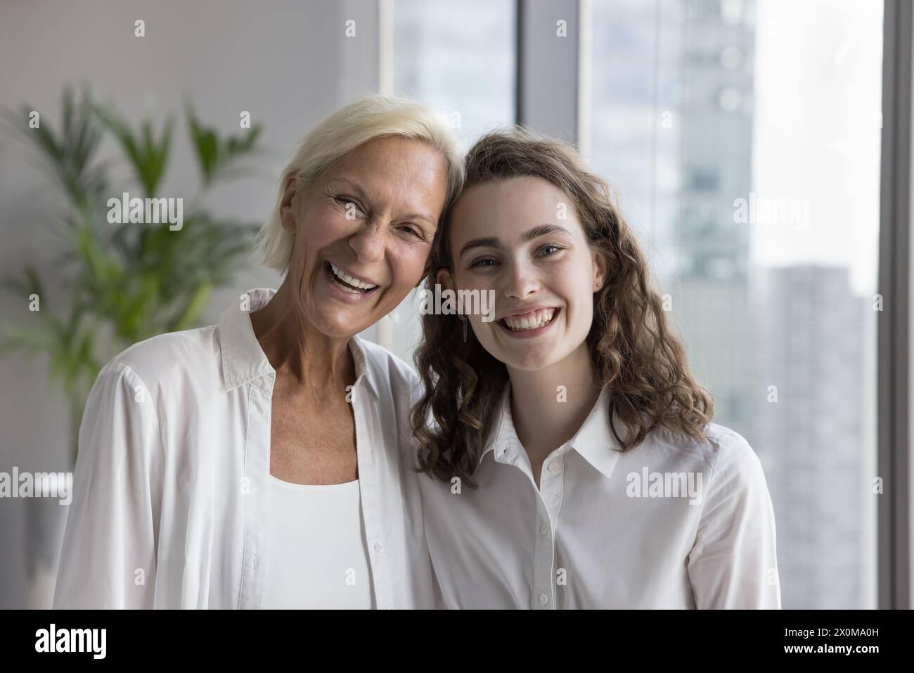 Two women, happy mother and adult daughter posing for camera Stock ...