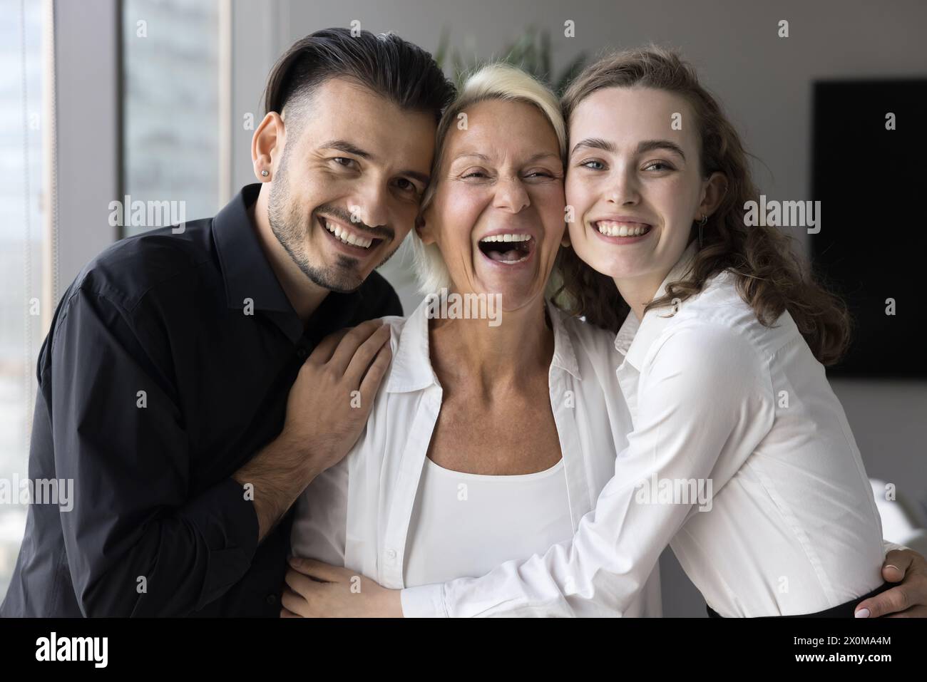 Three multigenerational colleagues relish success in office Stock Photo ...
