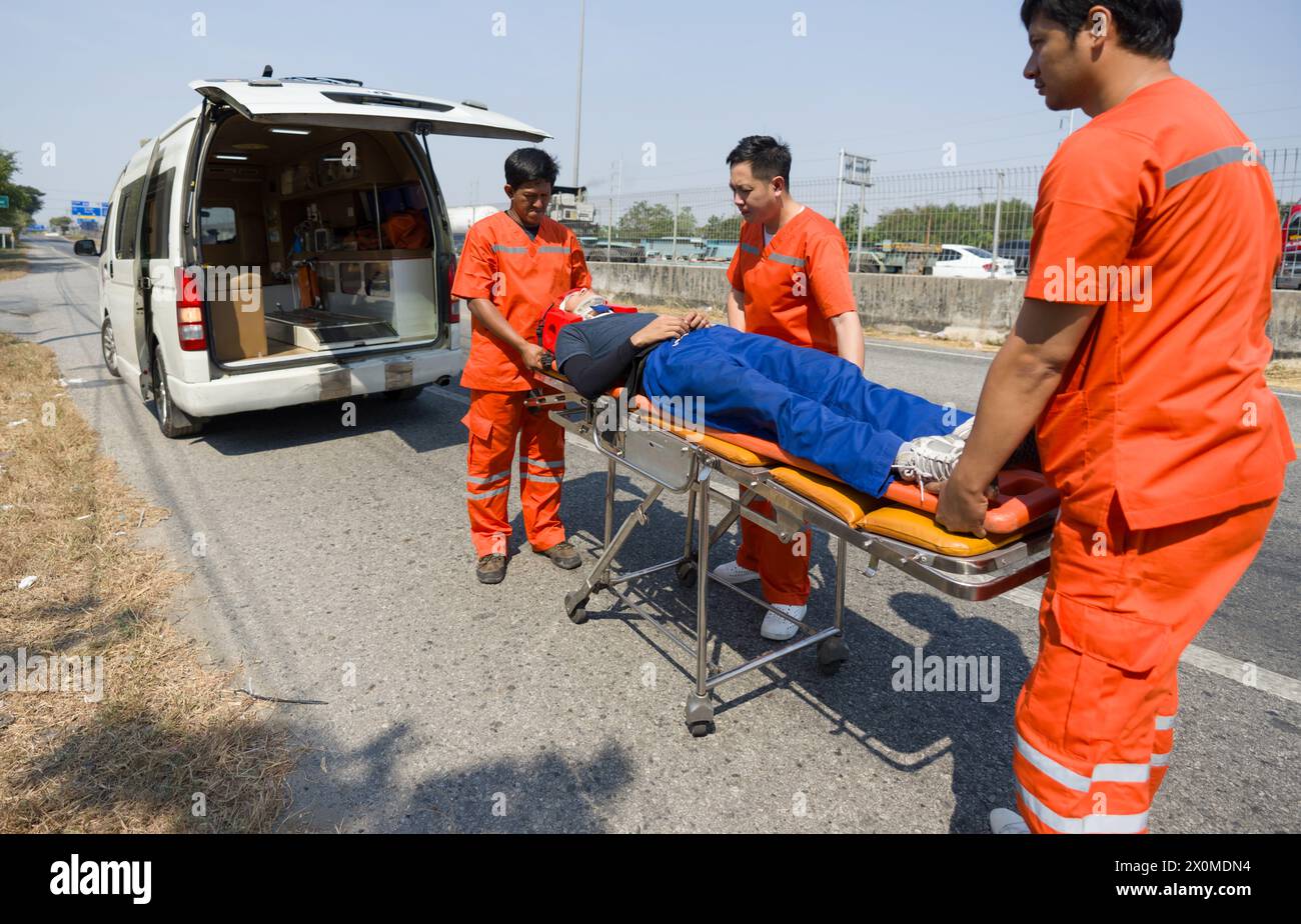 Group of paramedic or emergency medical technician (EMT) in orange ...