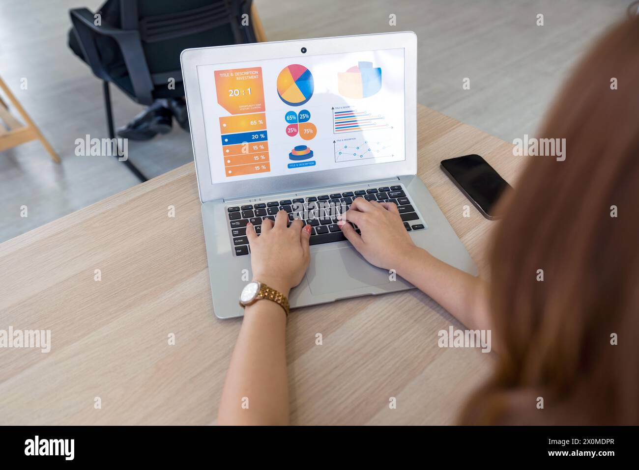 Back view of businesswoman sit at desk in office typing on laptop ...