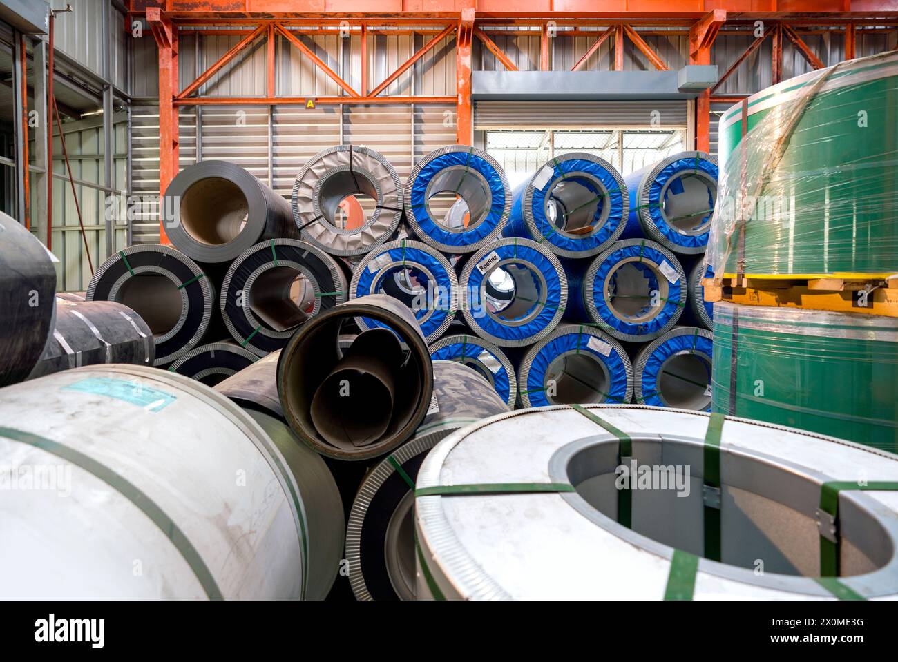 Steel coils stacked in a warehouse, ready for industrial use and ...