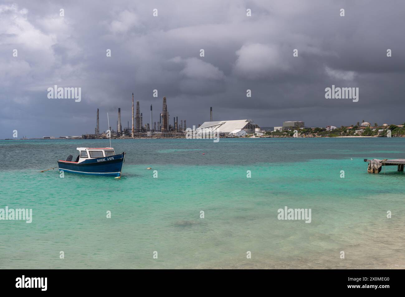 Aruba Refinery and lagoon with boat in fore ground - stormy sky Stock ...