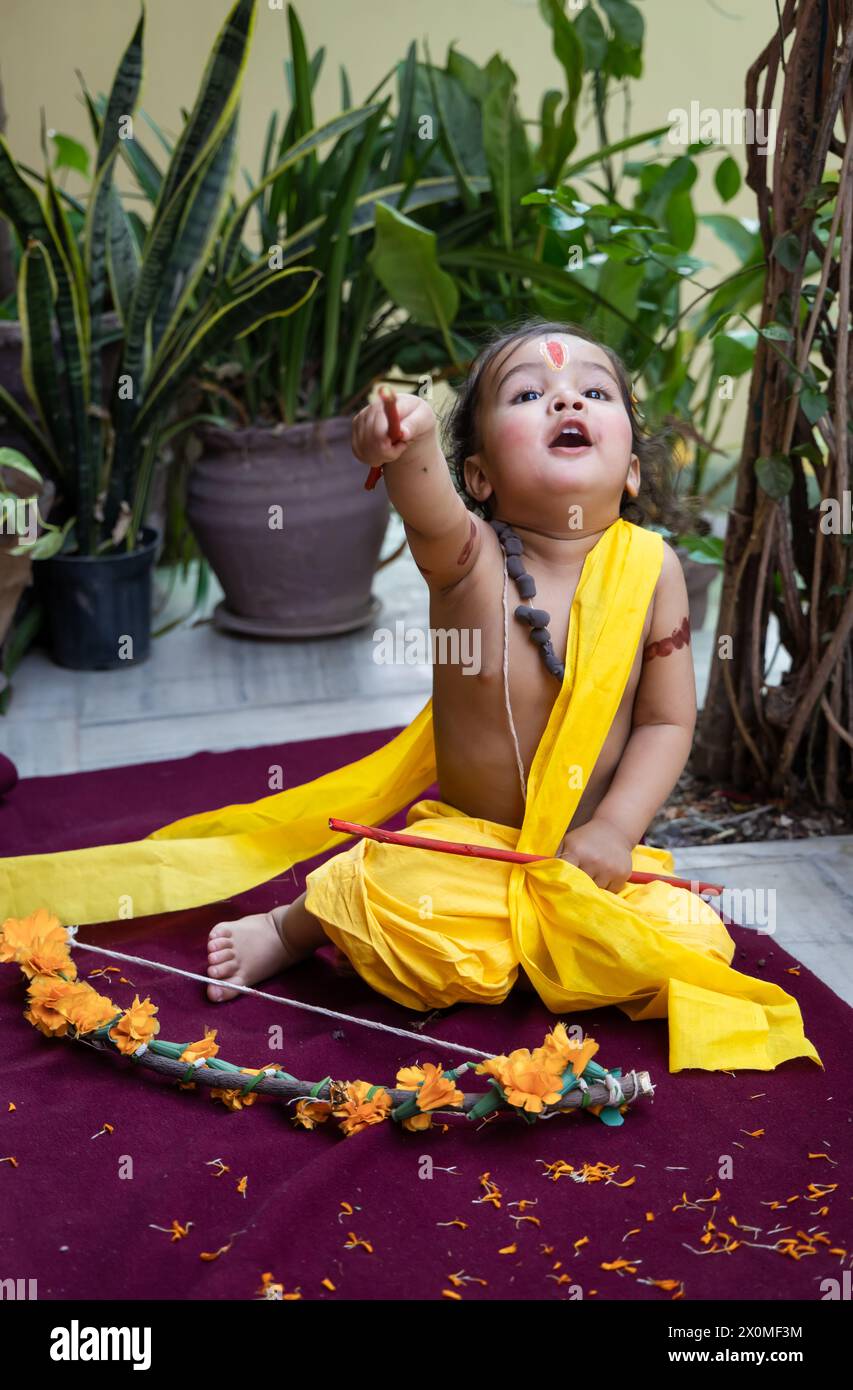 Portrait of cute Indian boy dresses as lord rama with bow at outdoor ...