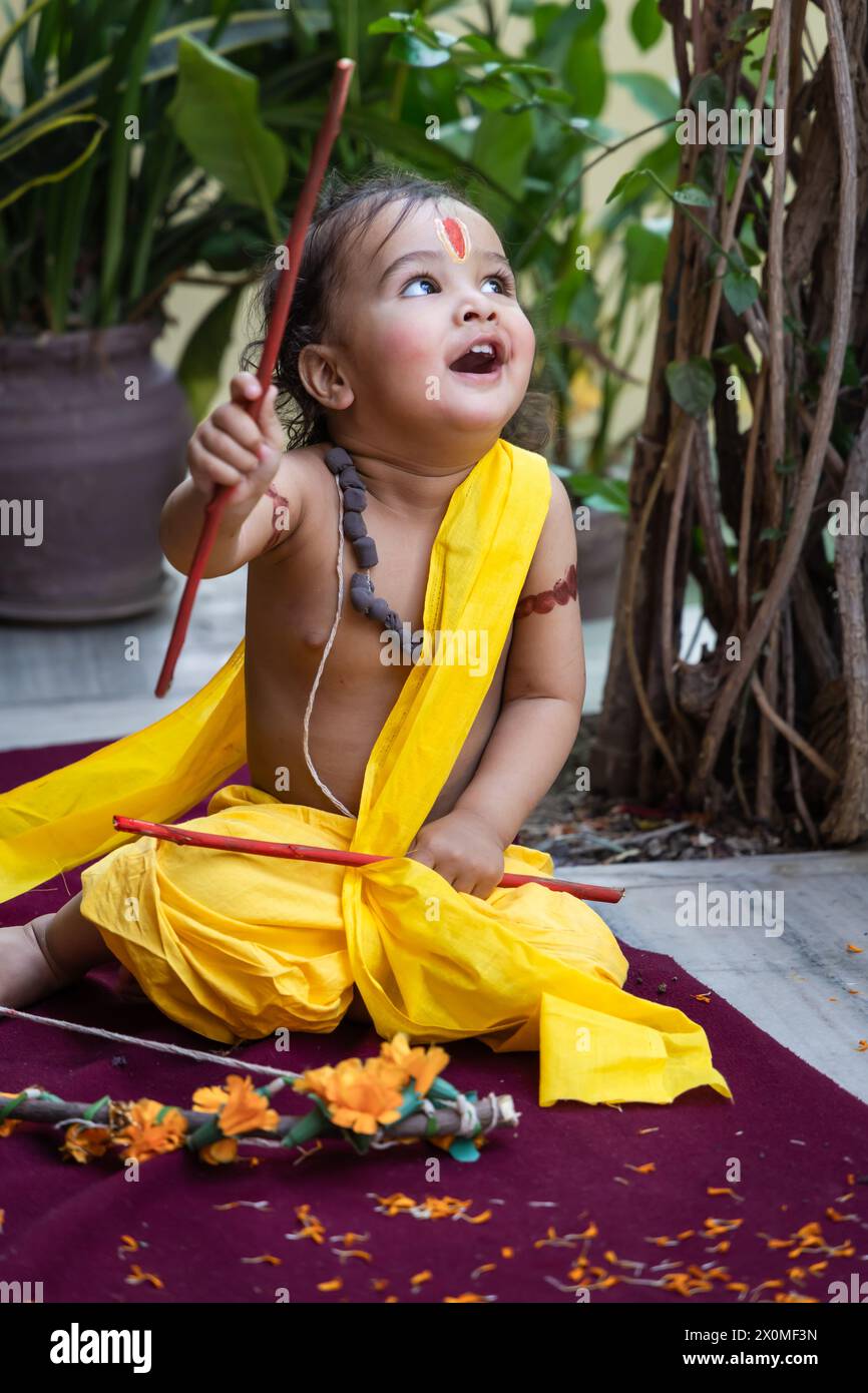 Portrait of cute Indian boy dresses as lord rama with bow at outdoor ...