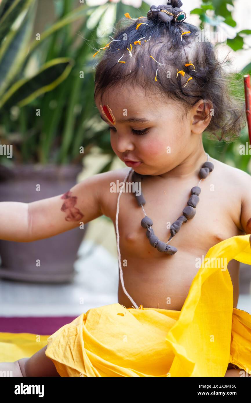 Portrait of cute Indian boy dresses as lord rama with bow at outdoor ...