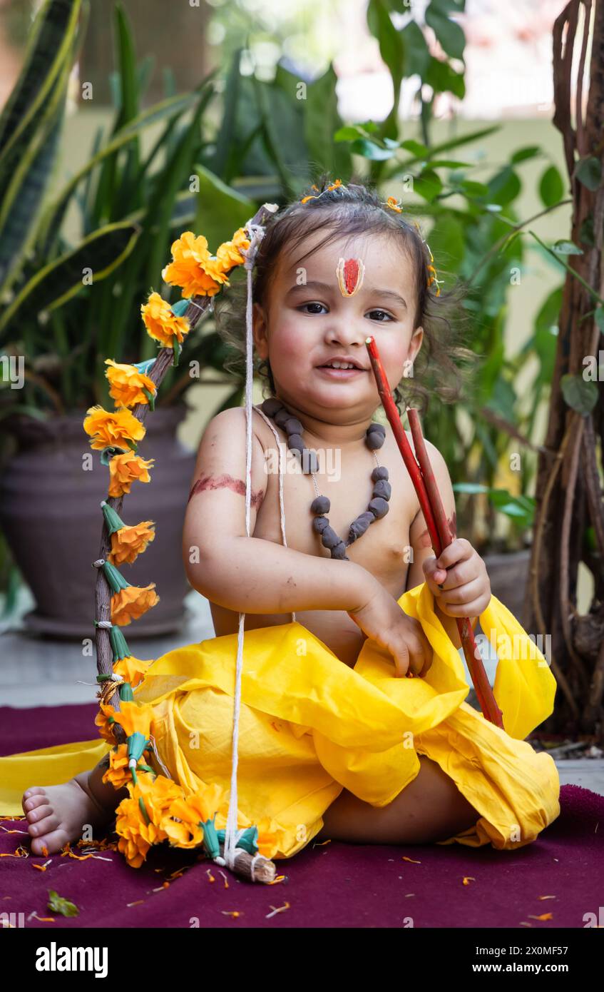 Portrait of cute Indian boy dresses as lord rama with bow at outdoor ...
