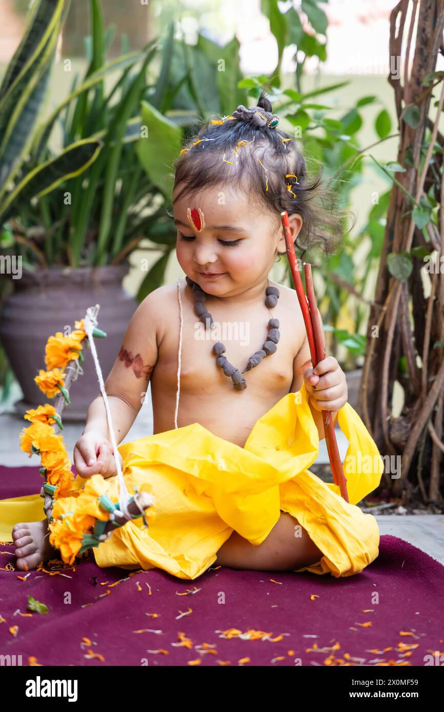 Portrait of cute Indian boy dresses as lord rama with bow at outdoor ...