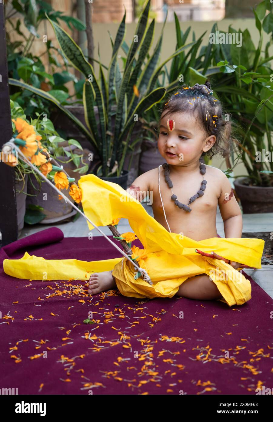 Portrait of cute Indian boy dresses as lord rama with bow at outdoor ...