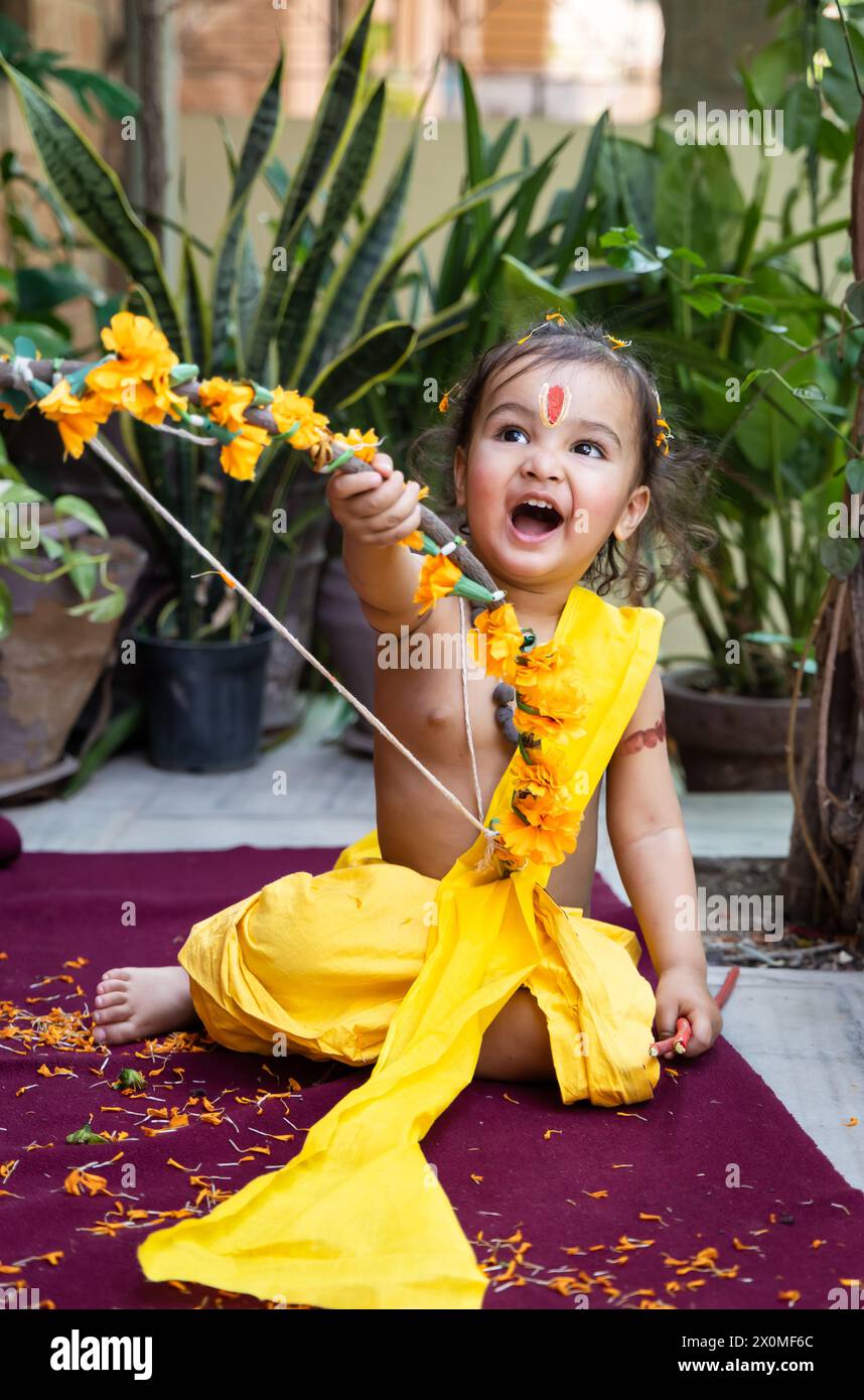 Portrait of cute Indian boy dresses as lord rama with bow at outdoor ...