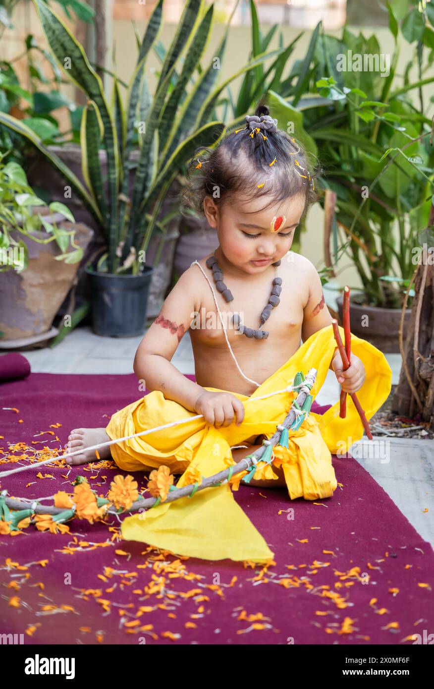 Portrait of cute Indian boy dresses as lord rama with bow at outdoor ...