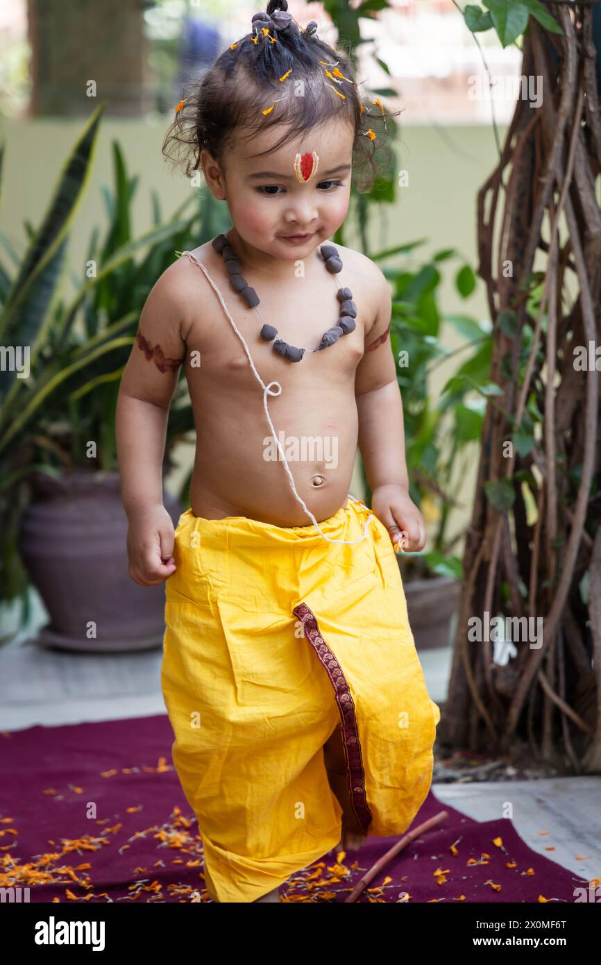 Portrait of cute Indian boy dresses as lord rama with bow at outdoor ...