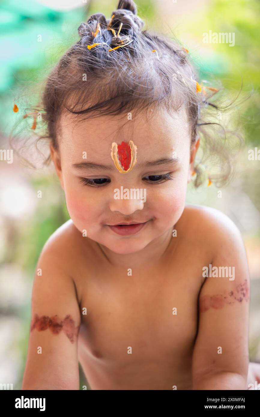 cute Indian boy with holy religious symbol on head at outdoor with ...