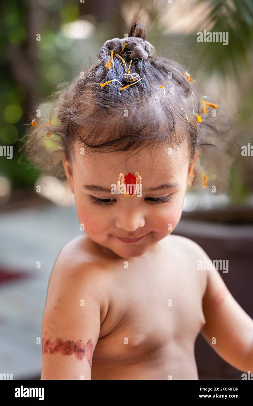 cute Indian boy with holy religious symbol on head at outdoor with ...