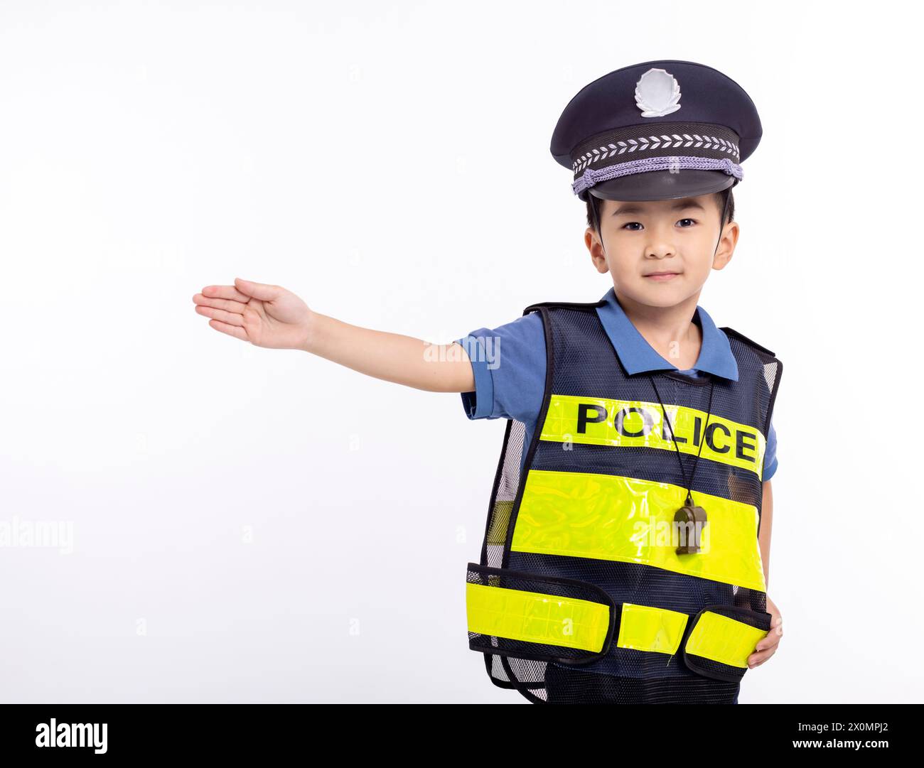 child dressed as a police officer standing before white background ...