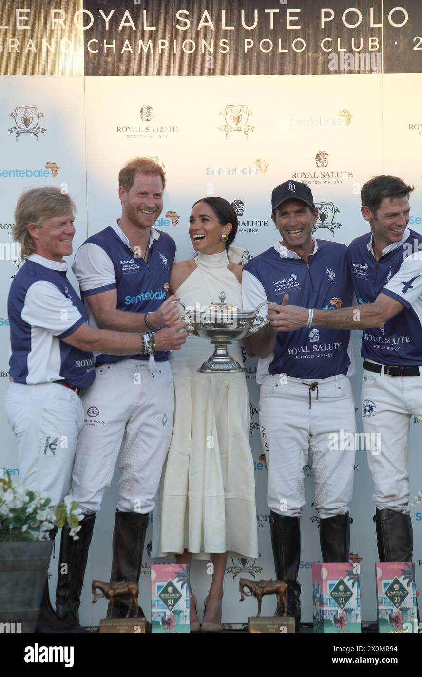The Duchess of Sussex presents the trophy to her husband, the Duke of ...