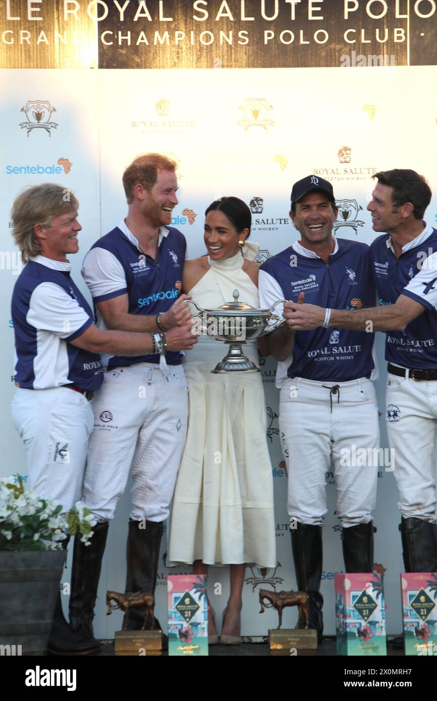The Duchess of Sussex presents the trophy to her husband, the Duke of ...