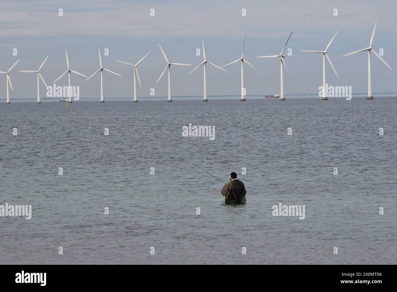 Fisherman and offshore wind turbines Amagar beach park Copenhagen ...