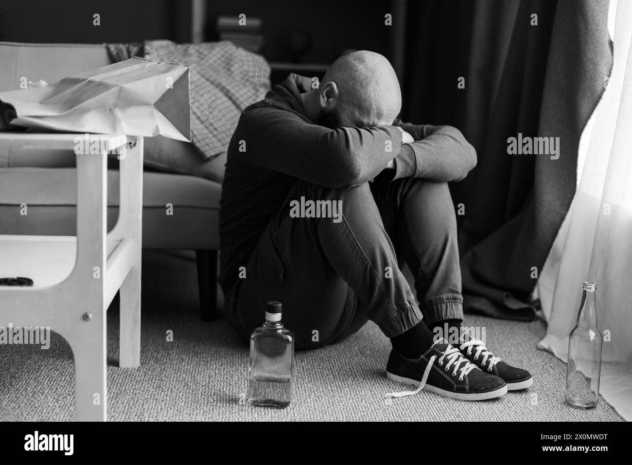 Black and white photo of a man suffering from alcoholism and depression ...
