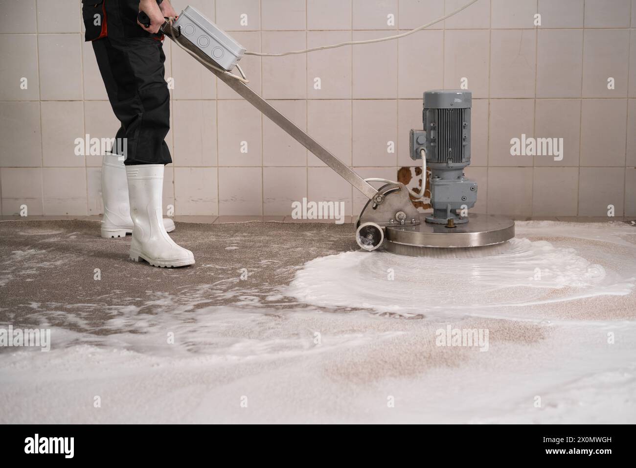 Worker cleaning vacuum cleaner carpets, washing carpet with disk ...